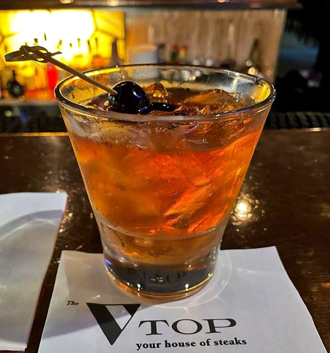 An Old Fashioned rests on The Top's napkin&mdash;liquid amber containing decades of cocktail craftsmanship and the promise of a memorable evening.