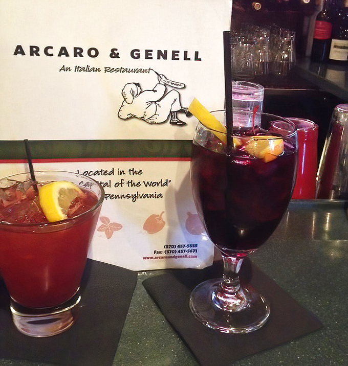 Cocktails with character at a bar where conversations flow as freely as the drinks. That paper placemat menu in the background tells you everything about this place's priorities.