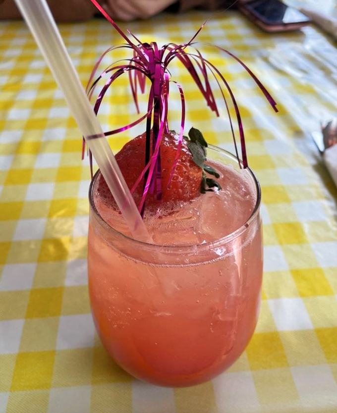 This isn't just a drink; it's summer in a glass, complete with a festive topper that says "yes, you deserve this."