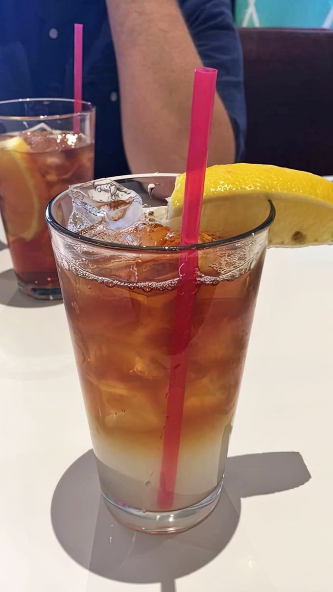 Iced tea with a pink straw and lemon wedge&mdash;because sometimes the simplest pleasures are the ones that keep you coming back for refills.