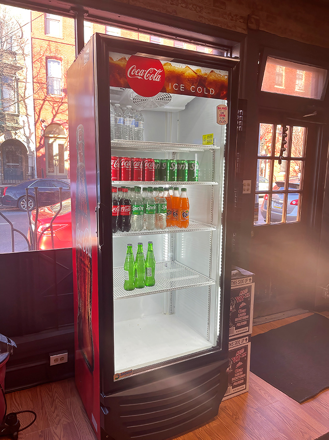 The beverage cooler stands ready, like a faithful companion waiting to extinguish the thirst that only great sandwiches can create.