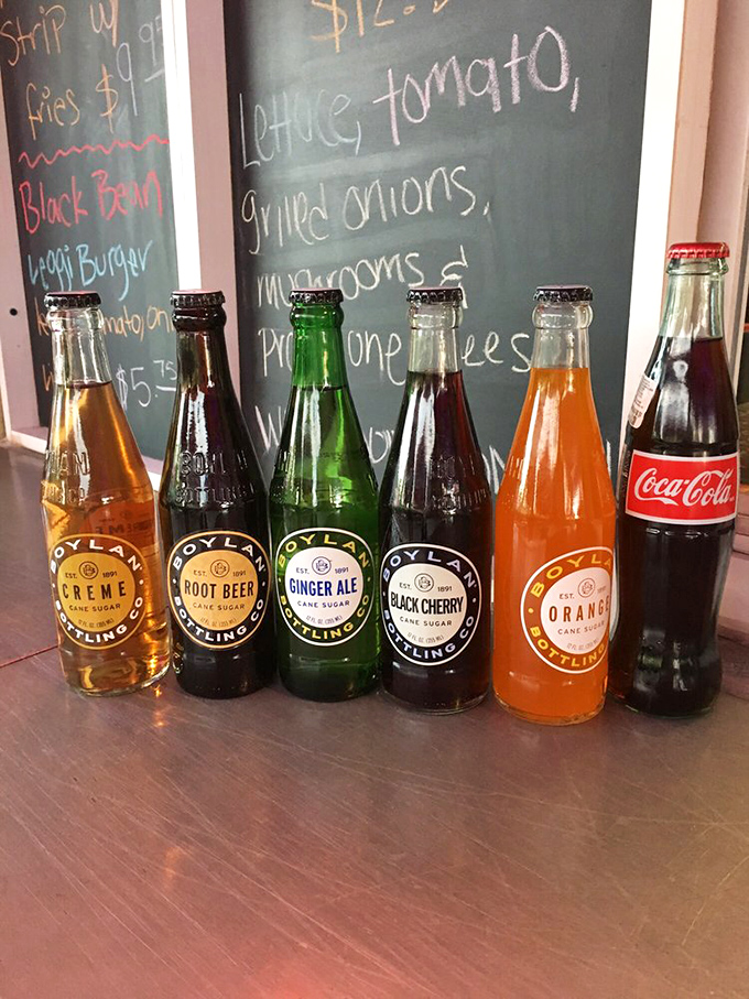 Craft sodas lined up like colorful soldiers, ready to wash down your feast in fizzy, refreshing style.