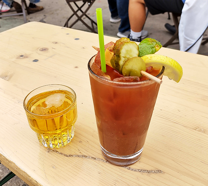 A Bloody Mary garnished like a vegetable garden met a pickle factory - Wisconsin brunch culture at its most gloriously excessive.