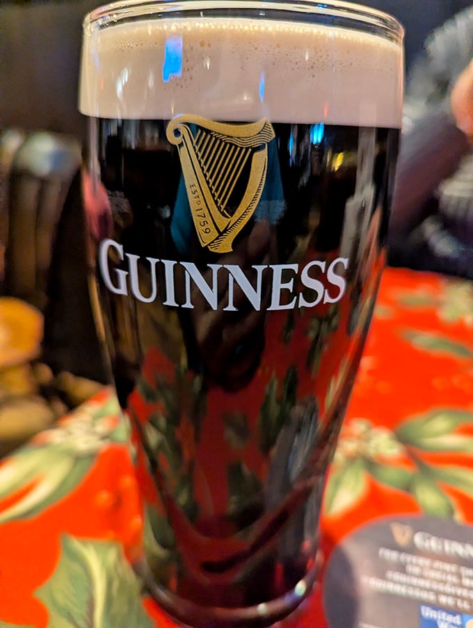 A perfectly poured Guinness awaits its destiny. In the sandwich kingdom of McNally's, even the beverages dress for the occasion.