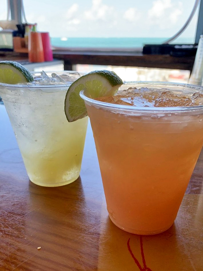 Tropical cocktails with lime garnishes, because paradise tastes better with proper presentation and ocean views.