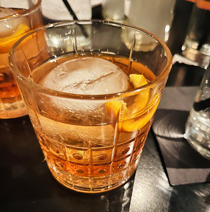 An Old Fashioned that Don Draper would approve of&mdash;amber liquid, oversized ice cube, and just enough orange zest to make things interesting.