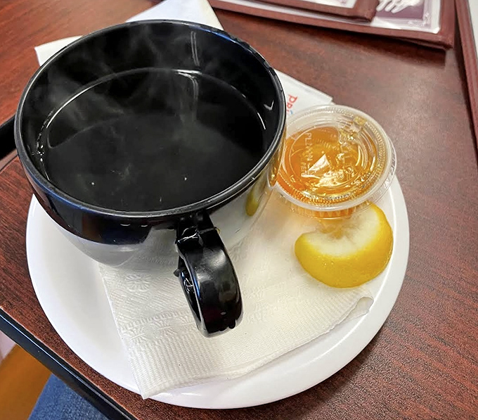 Coffee served with a slice of lemon&mdash;a European touch that says, "We care about the little details that elevate your morning."