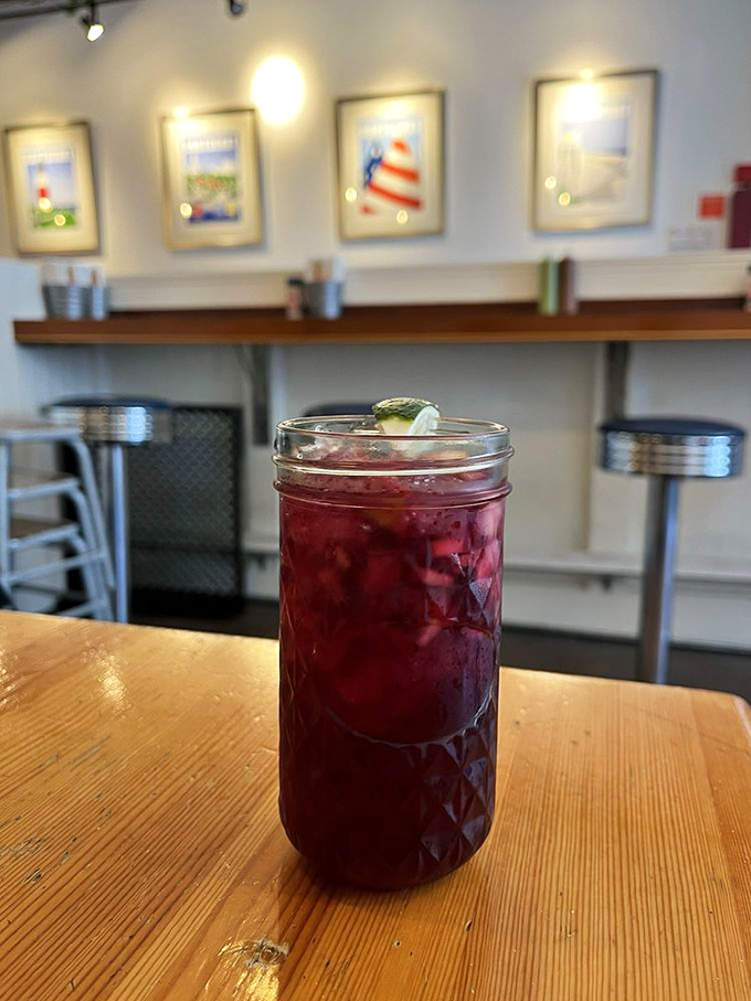 That vibrant sangria isn't just a drink—it's a ruby-colored vacation in a mason jar, complete with a cucumber life preserver.