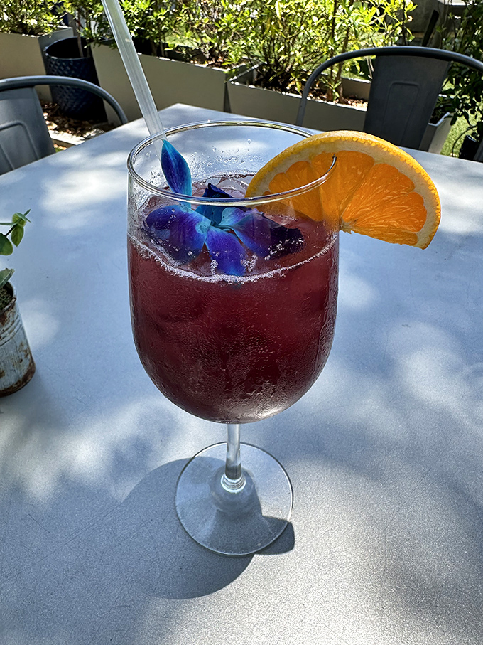 Sunshine in a glass! This vibrant cocktail with its edible flower garnish captures Florida's playful spirit &ndash; vacation in liquid form.