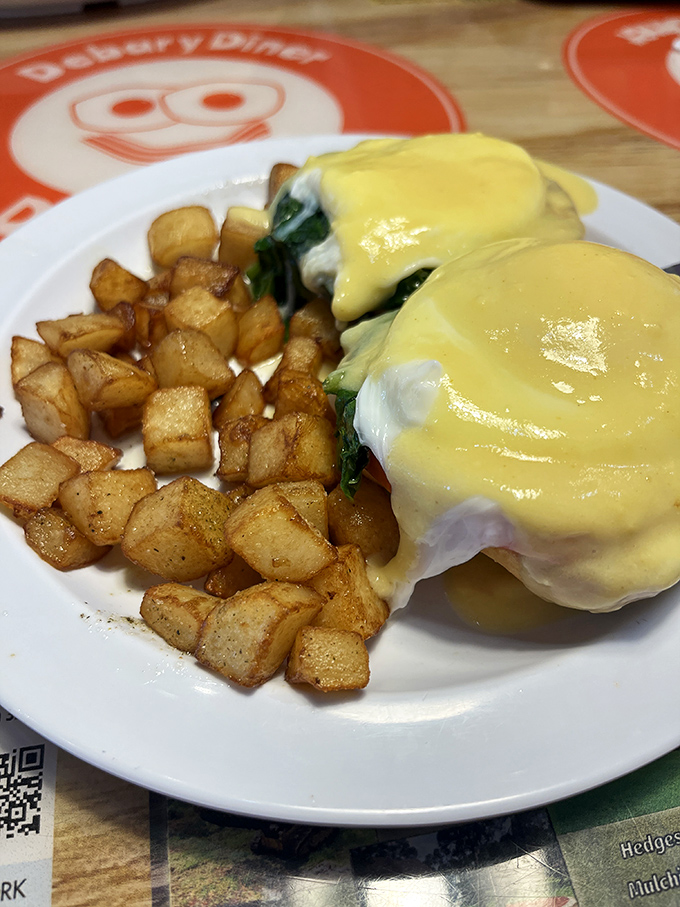 Eggs Benedict that would make a brunch snob swoon. That hollandaise sauce looks like liquid sunshine cascading over perfectly poached eggs.