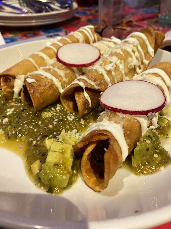 Golden enchiladas de pollo swimming in sauce represent comfort food at its most persuasive and delicious.