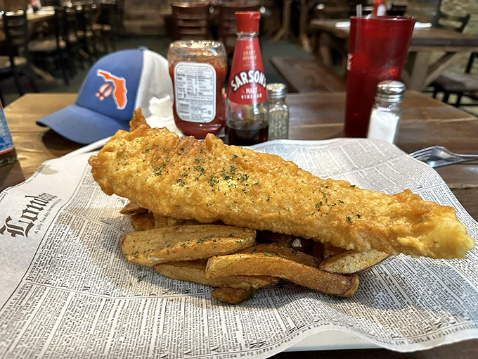 Fish and chips served on newspaper&mdash;a crispy golden reminder that sometimes the simplest foods are life's greatest pleasures.