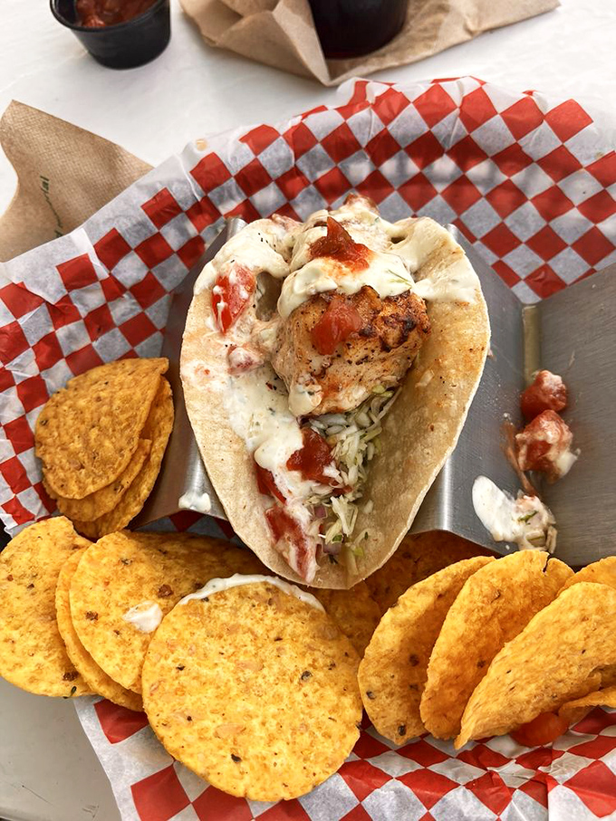 This fish taco isn't just a meal, it's a beach vacation wrapped in a tortilla. The crispy chips standing guard are a nice touch.