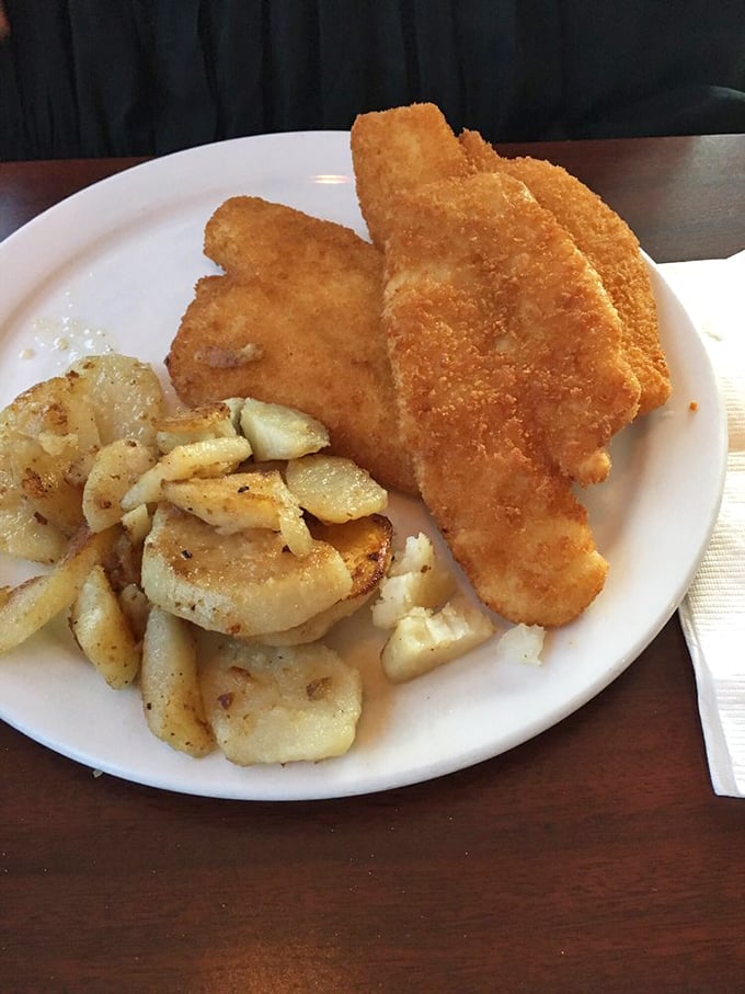 Golden-fried perfection alongside seasoned potatoes&mdash;proof that simple food executed flawlessly beats fancy cuisine any day of the week.