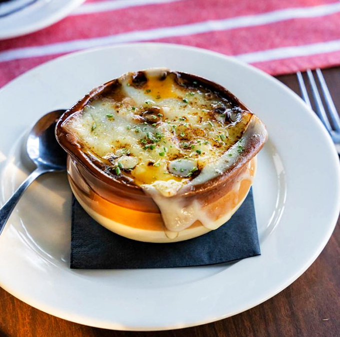 French onion soup that's having an identity crisis as a cheese delivery system. That golden cap of bubbling goodness is worth the inevitable chin dab.