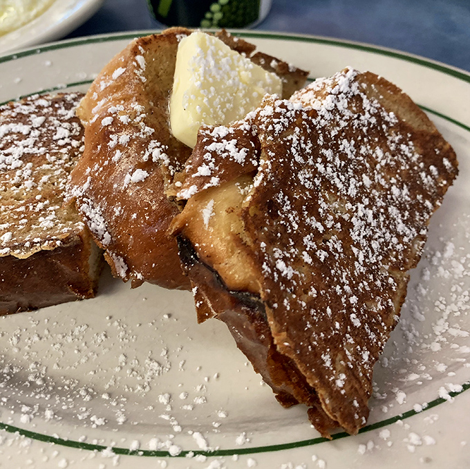 French toast that makes ordinary bread feel inadequate. Dusted with powdered sugar like fresh snow on a delicious landscape.