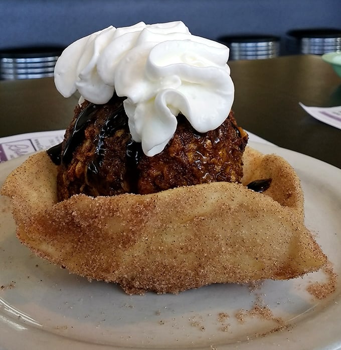 Fried ice cream: where hot meets cold in a cinnamon-sugar embrace that defies physics and delights taste buds in equal measure.