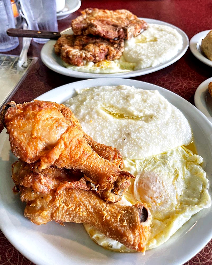 Golden-fried chicken with creamy grits and eggs—a plate that makes you understand why some people dream about breakfast.