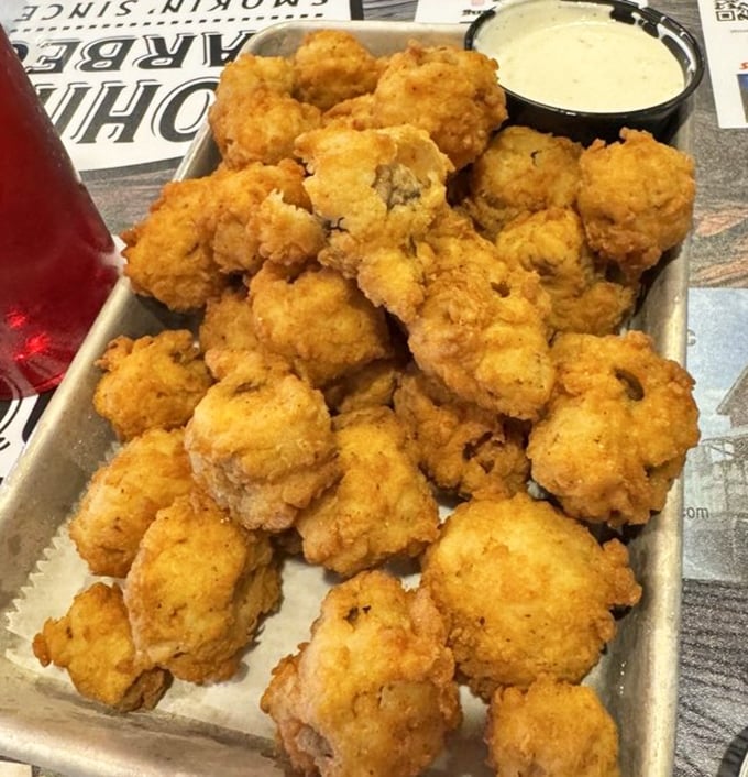 These golden-fried mushrooms aren't just appetizers&mdash;they're little flavor bombs waiting to explode. Paired with that dipping sauce, they're the opening act that threatens to upstage the headliner.