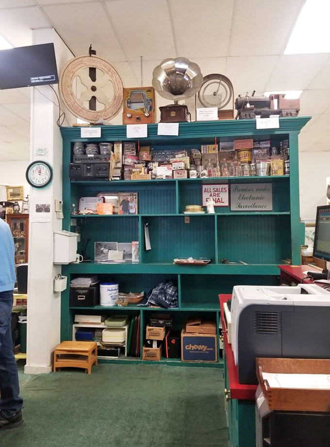 The command center of nostalgia, where vintage tins and antique gadgets perch above the register like guardians of retail history.