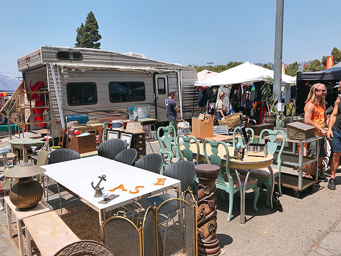 Mid-century meets millennial as seafoam chairs and weathered tables create an impromptu furniture showroom under the California sun.