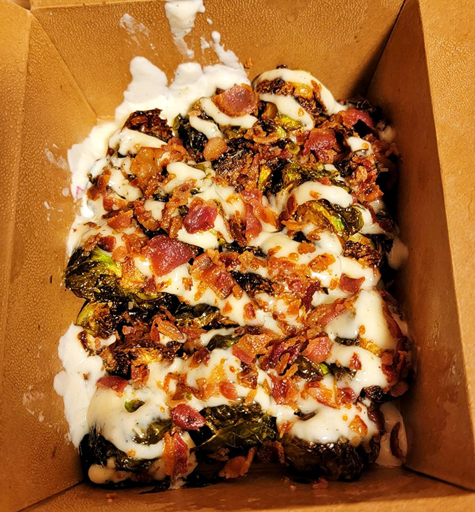 Brussels sprouts that could convert the most dedicated vegetable skeptic—crispy, bacon-studded, and drizzled with what appears to be a heavenly sauce.