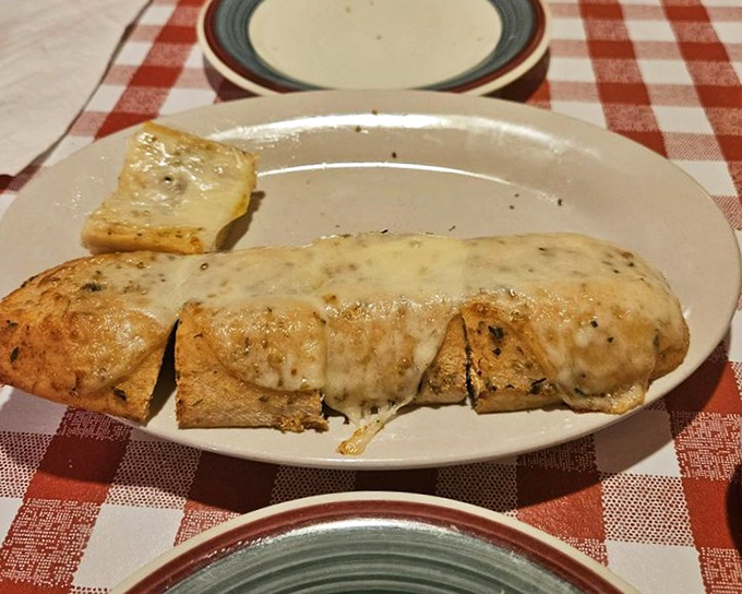 Garlic bread that doesn't whisper its presence—it announces itself to the room and possibly the neighboring zip code. Worth every breath mint afterward.