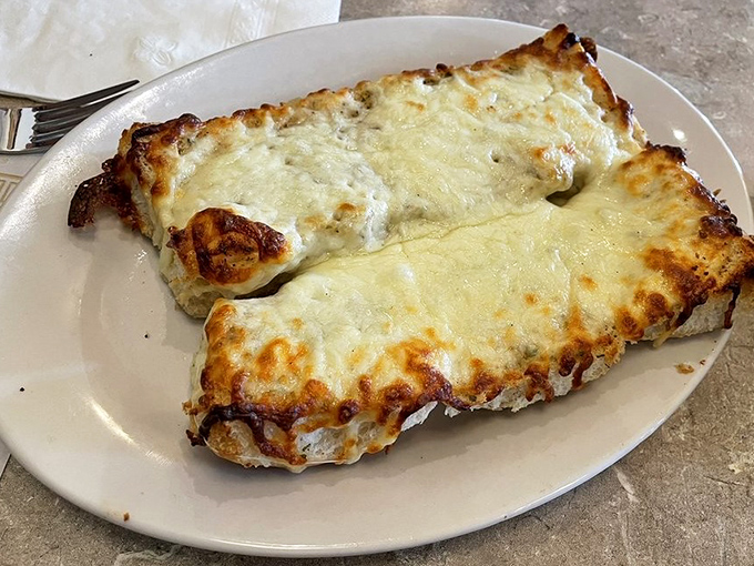 Garlic bread that's achieved the impossible balance &ndash; crispy edges, melty cheese, and enough garlic to keep vampires at bay for at least a fortnight.
