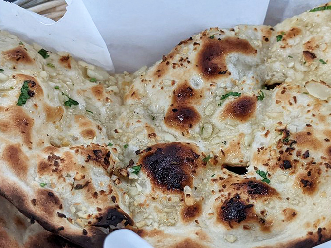 Garlic naan with those perfect char spots is the unsung hero of Indian cuisine &ndash; part utensil, part side dish, all delicious.