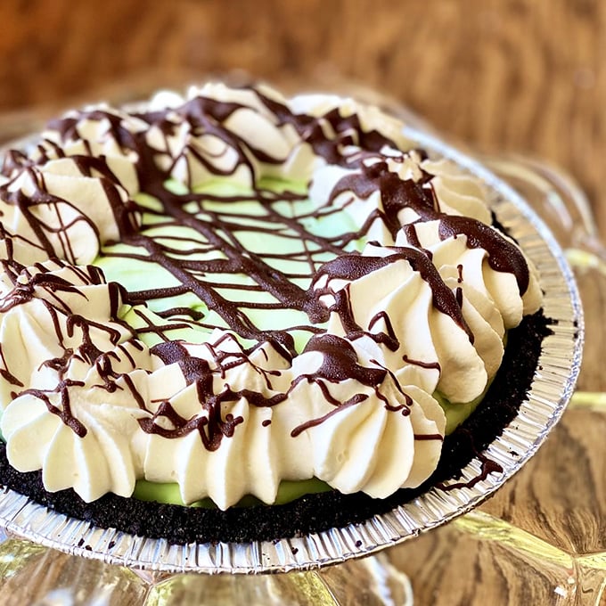 The Grasshopper pie's chocolate crust cradles mint cream like it's protecting the Hope Diamond, only this treasure you're allowed to devour.
