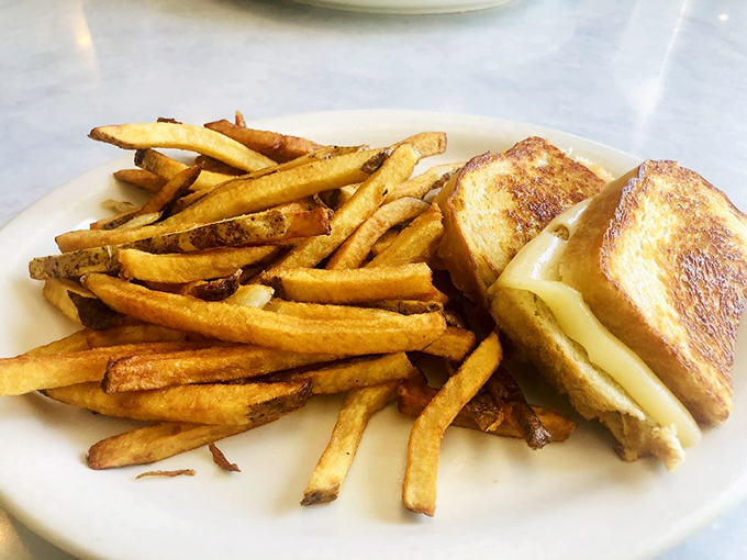 Grilled cheese perfection isn't complicated&mdash;just perfectly golden bread, melty cheese, and enough fries to make you forget you're an adult with responsibilities.