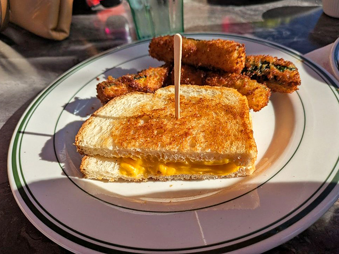 Grilled cheese elevated from childhood memory to grown-up indulgence. Those zucchini sticks aren't just a side—they're the wingmen this sandwich deserves.