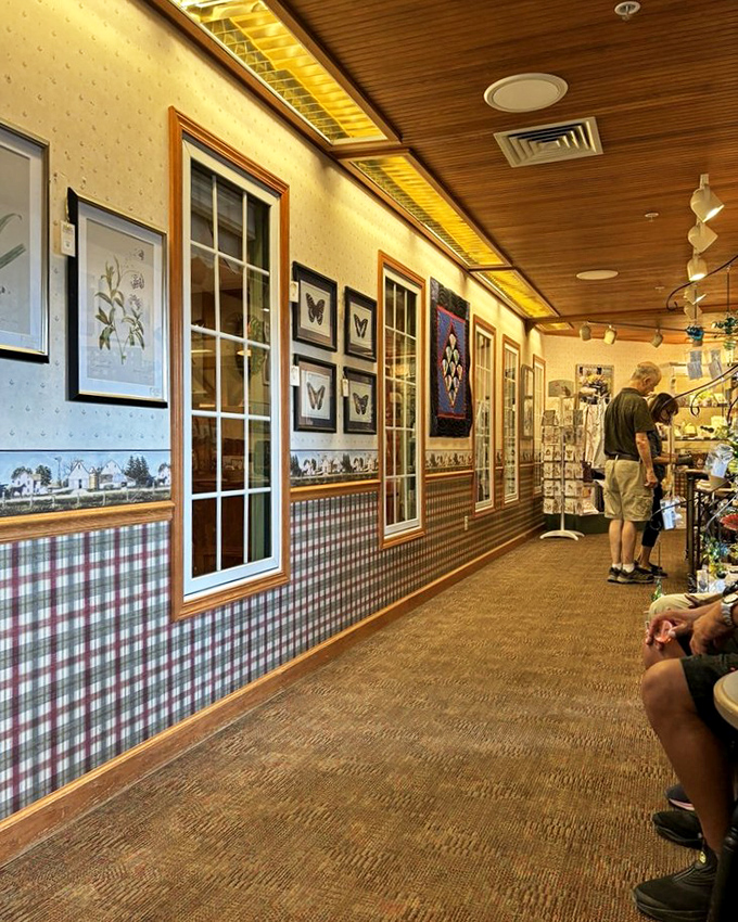 The hallway at Essenhaus doubles as a mini-museum of local culture, where plaid wallpaper and framed artwork create a homey gallery experience.