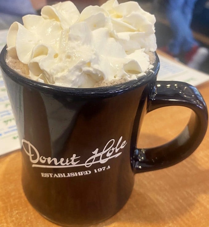 Hot chocolate that's dressed for success with a whipped cream hat so tall it deserves its own zip code.