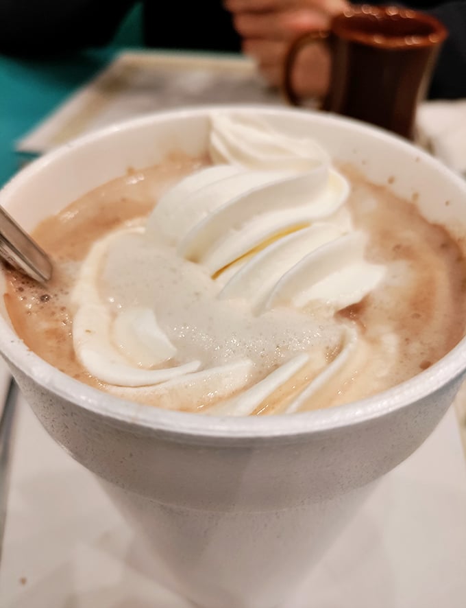 Hot chocolate that doesn't just warm your hands but renovates your soul, topped with whipped cream swirled like a cloud formation worthy of a weather report.
