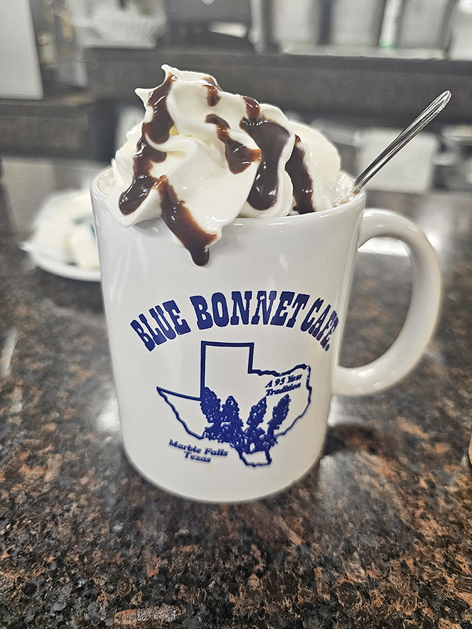 Hot chocolate crowned with whipped cream - comfort in a mug bearing local pride.