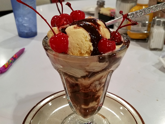 This hot fudge sundae isn't just dessert&mdash;it's therapy in a glass, complete with those artificially bright cherries we secretly love.
