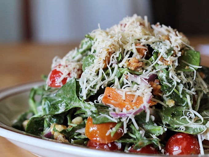 A salad that makes you forget you're being virtuous. Fresh greens, vibrant veggies, and a snowfall of cheese&mdash;health food never looked so tempting.