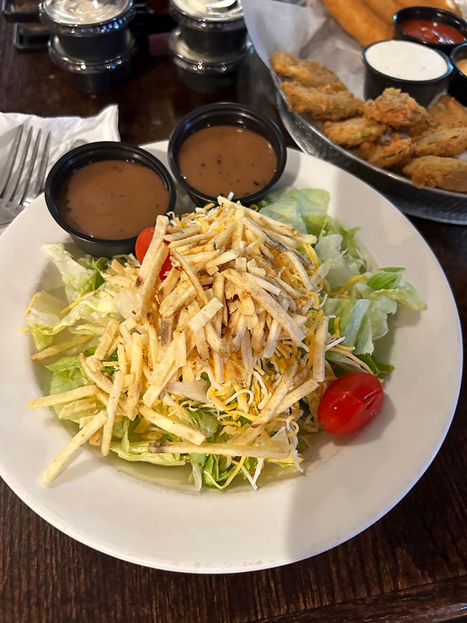 A house salad that actually deserves the name "salad" rather than "sad pile of wilted lettuce." Those potato sticks on top? Pure genius.