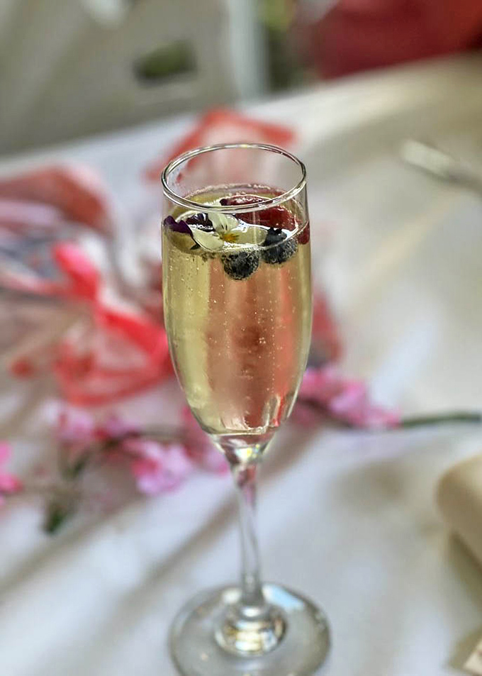 A champagne flute with berries floating like tiny jewels&mdash;because Tuesday afternoons sometimes need their own celebration.