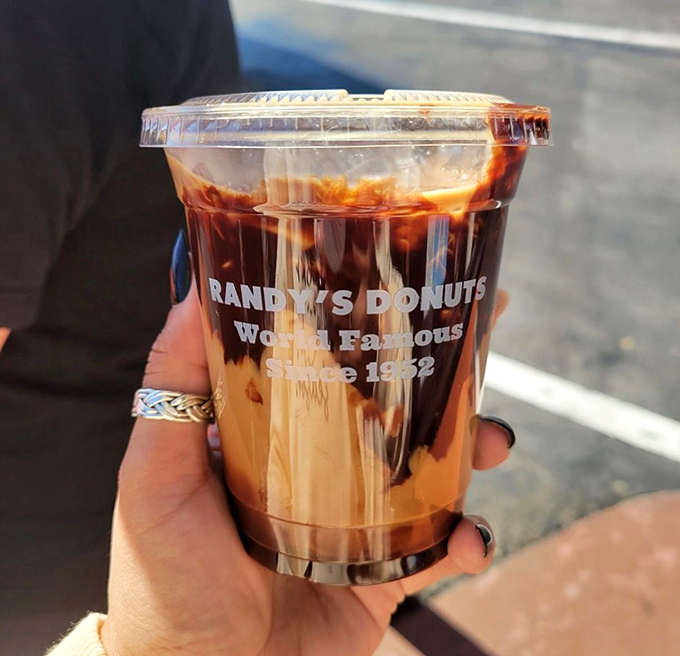 Liquid motivation in a cup. Randy's iced mocha provides the perfect caffeine companion to your donut adventure, emblazoned with their famous logo.