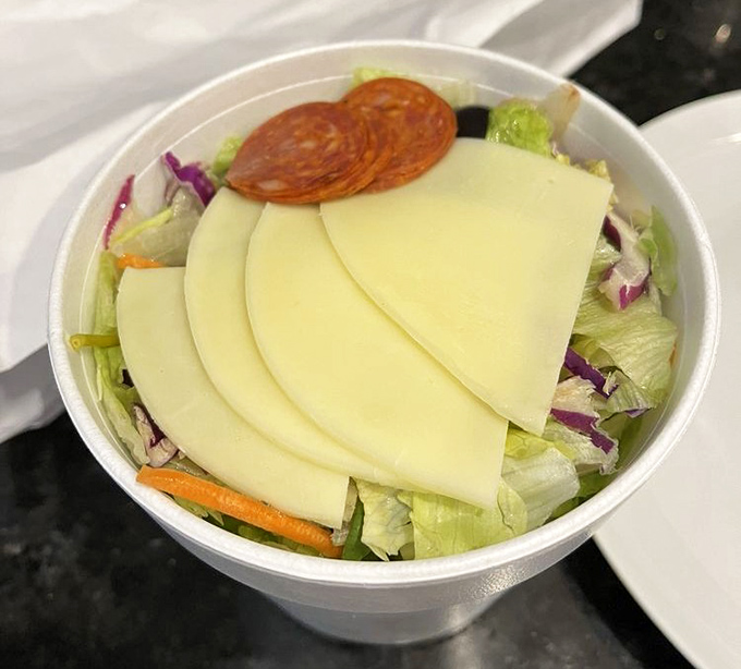 An Italian salad that doesn't apologize for its simplicity&mdash;crisp lettuce, generous cheese slices, and pepperoni that reminds you vegetables are just pizza topping delivery vehicles.