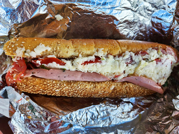 Sesame seeds stand guard over layers of meat, cheese, and veggies in this Italian sub that demands to be eaten with both hands.