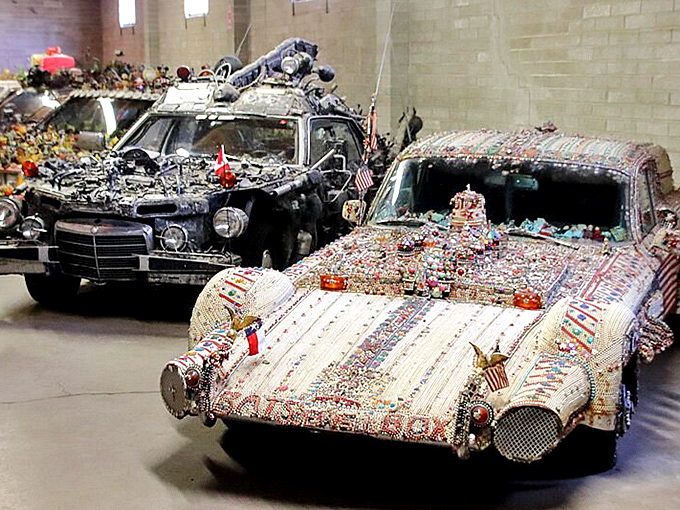 
This car is an elaborately decorated art vehicle covered in countless colorful trinkets, beads, and miniature figures, turning it into a rolling piece of eccentric, eye-catching sculpture. 