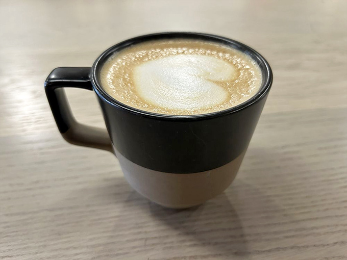Coffee served with intention in a two-tone mug that says, "Yes, we take our caffeine seriously, but we don't need to be pretentious about it."