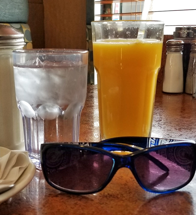 Morning decisions made easier with fresh-squeezed orange juice that practically glows with vitamin C, ready to jumpstart your day alongside ice water for balance.