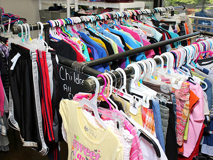 The children's clothing section: where growth spurts meet budget-friendly solutions. A rainbow of tiny garments promising adventures, spills, and inevitable outgrowing.