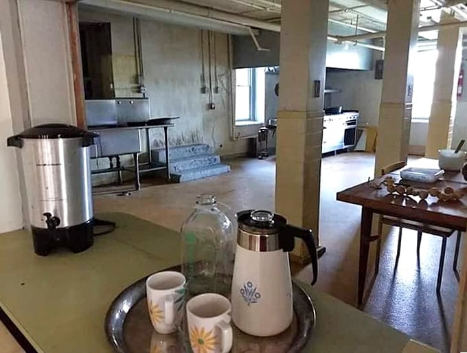 The institutional kitchen once fed hundreds. That coffee pot might have brewed thousands of cups for staff working long, difficult shifts.