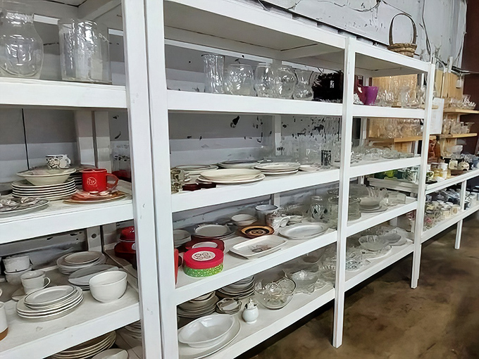 White shelves lined with glassware, dishes, and kitchen essentials&mdash;the perfect starting point for first apartments or vintage-loving entertainers.