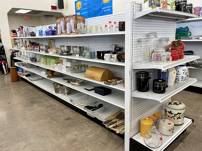 Kitchen implements of every era line these shelves. That yellow ceramic cookie jar probably held someone's grandma's secret stash of snickerdoodles.